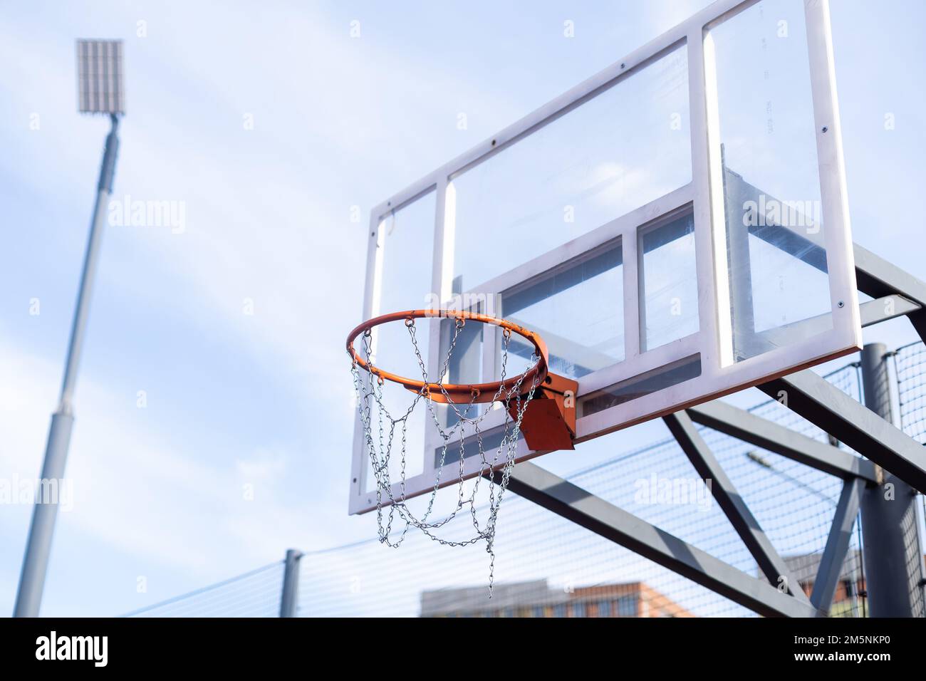outdoor basketball in front of a blue sky. The basketball hoop or ring ...