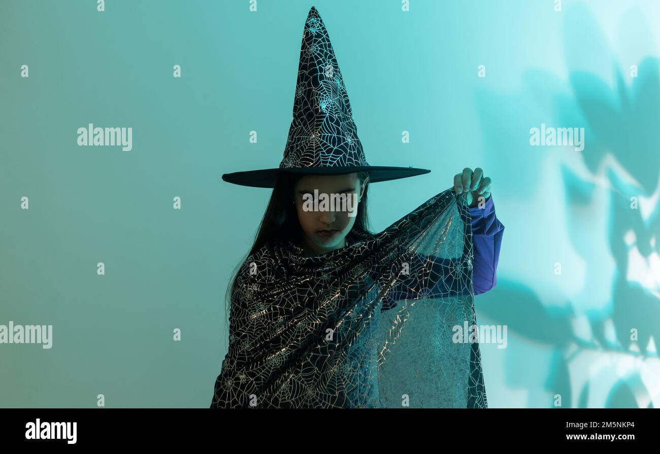 Happy scary Halloween concept: little witch girl playing paranormal ...