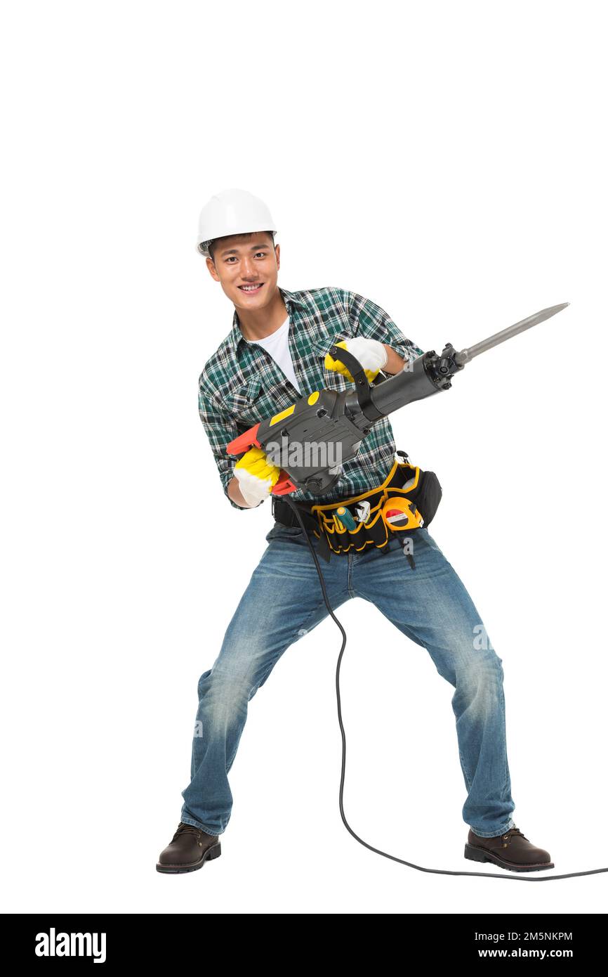 Young construction workers take percussion drill Stock Photo - Alamy