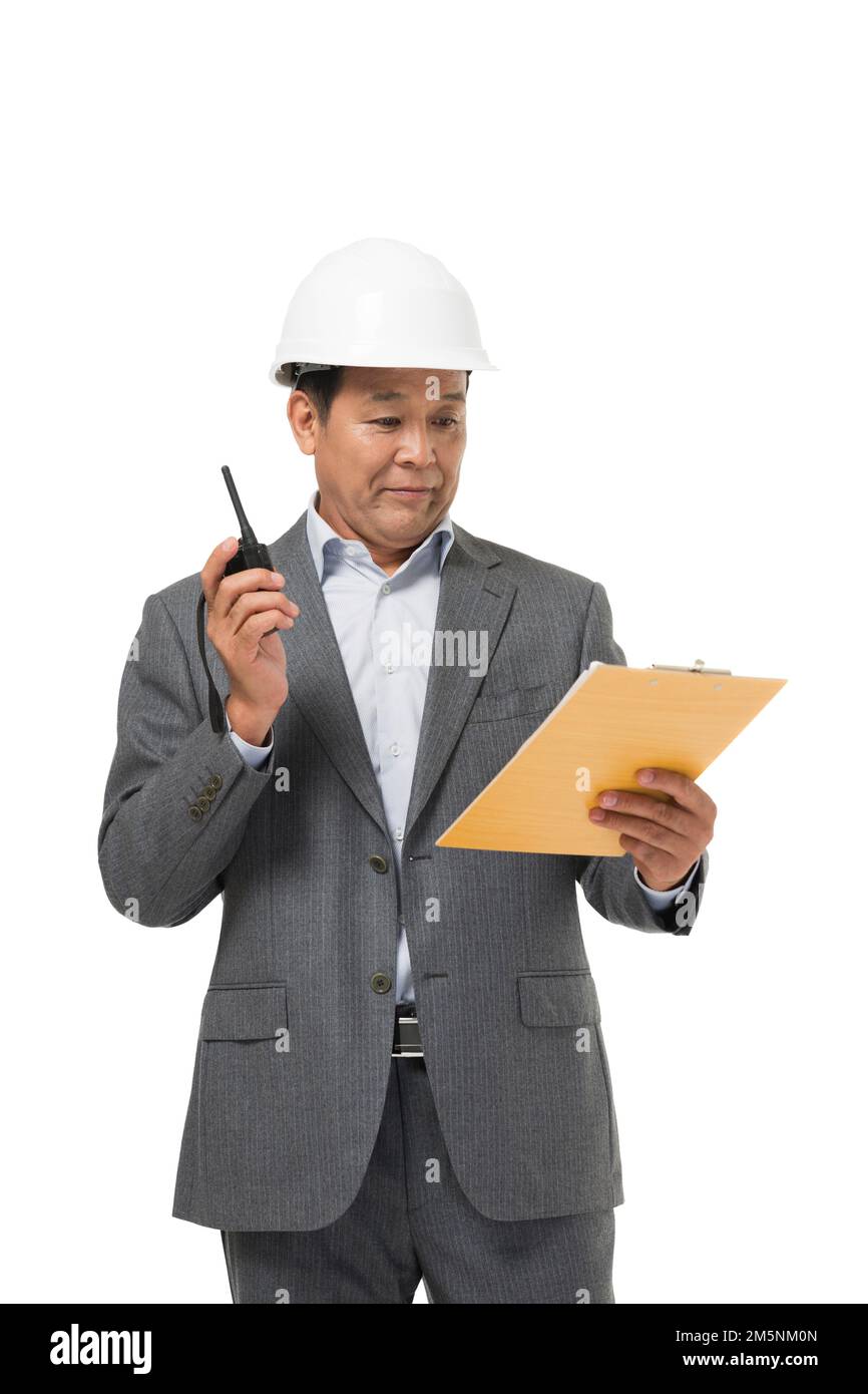 Middle-aged male construction engineer holding a radio command Stock ...