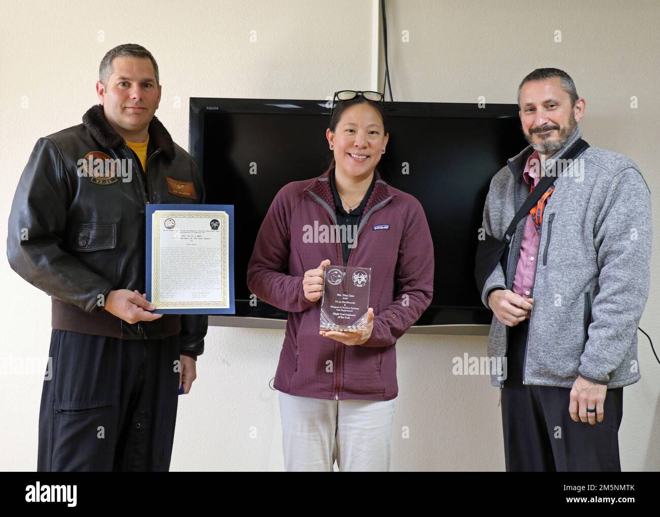 Cmdr. Jason Saglimbene, left, and Dan Toland, right, present Tina Liao ...