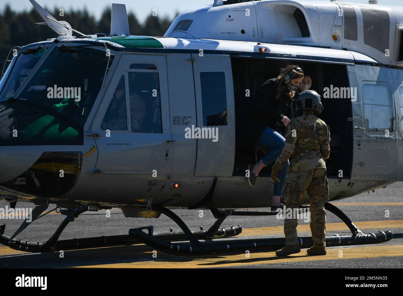 A Yokota spouse leaps from a UH-1N Huey helicopter assigned to the 459th Airlift Squadron during ...