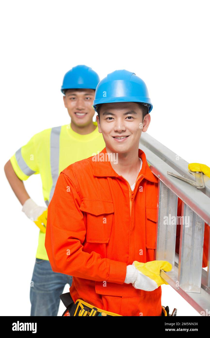 Young workers carrying a ladder Stock Photo - Alamy