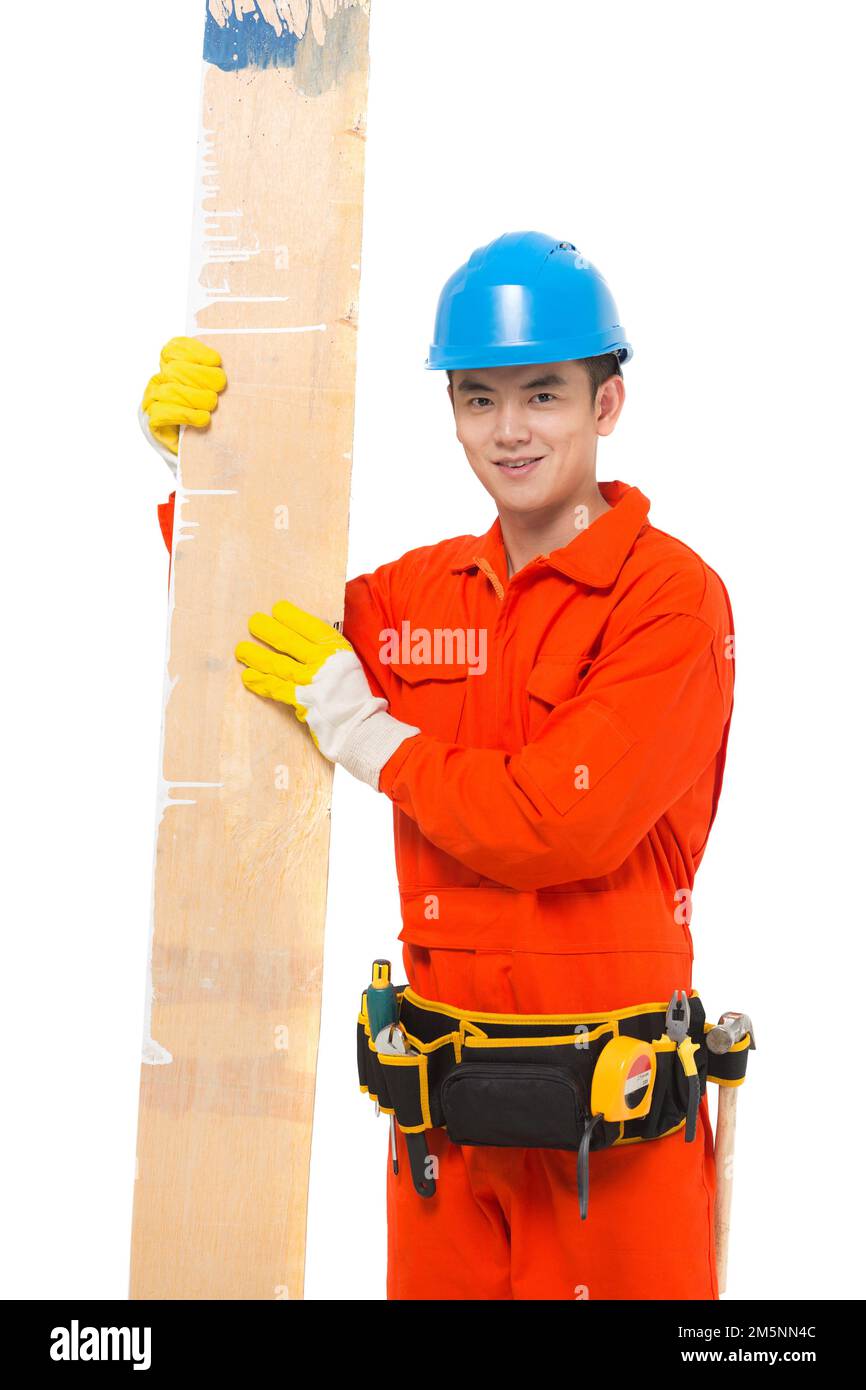 Young construction workers carry building materials Stock Photo - Alamy