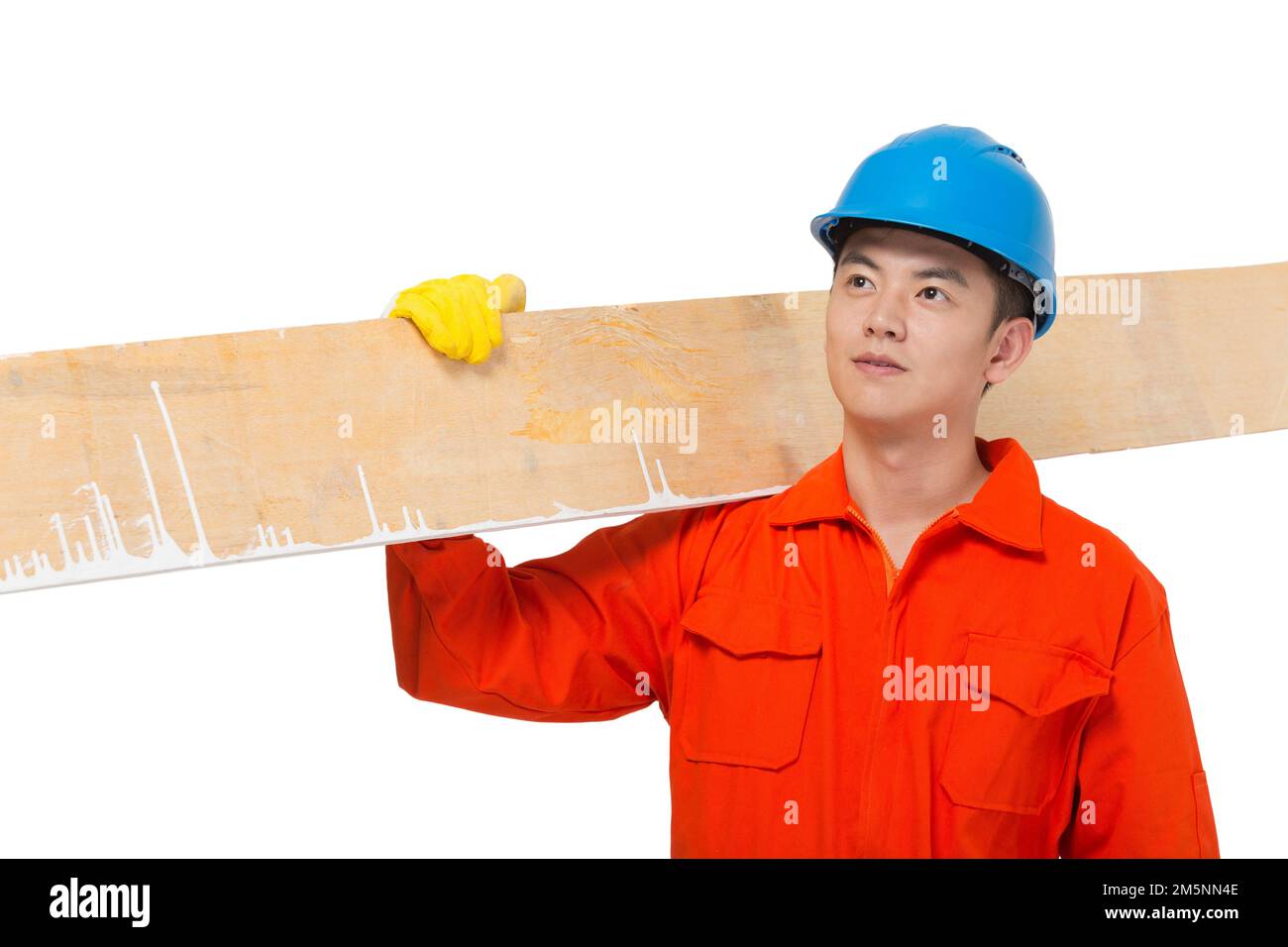 Young construction workers carry building materials Stock Photo - Alamy