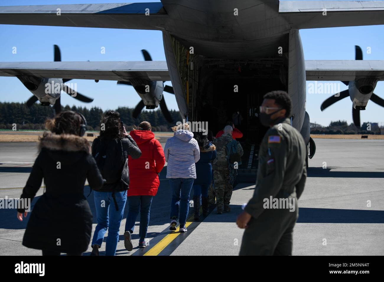 Yokota spouses enter the rear exit ramp of a C-130J Super Hercules ...