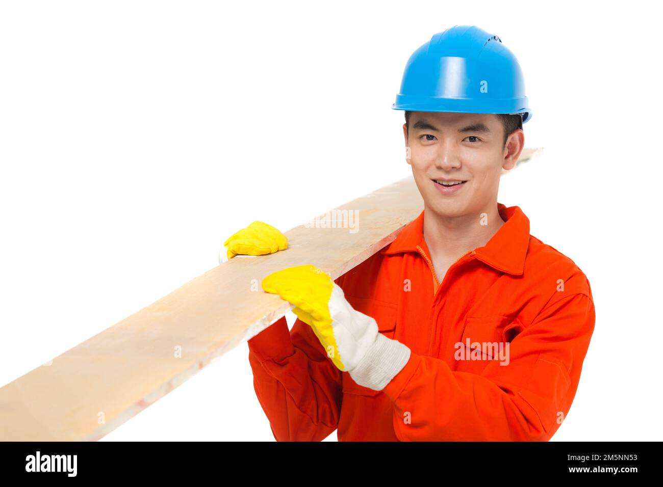 Young construction workers carry building materials Stock Photo - Alamy