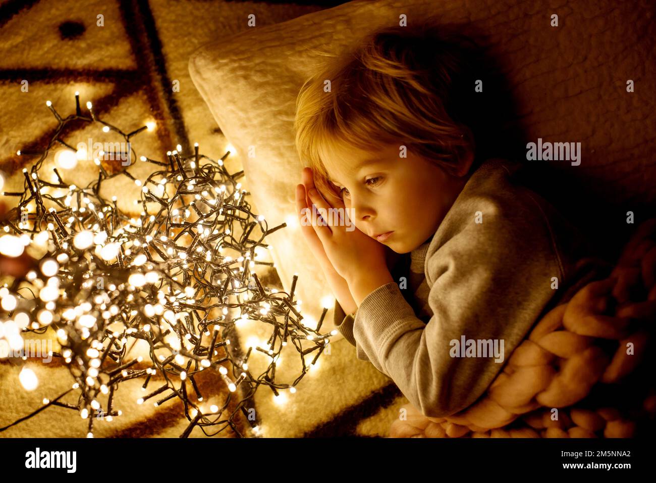 Toddler child, cute blond boy, sleeping in bed at night with christmas ...
