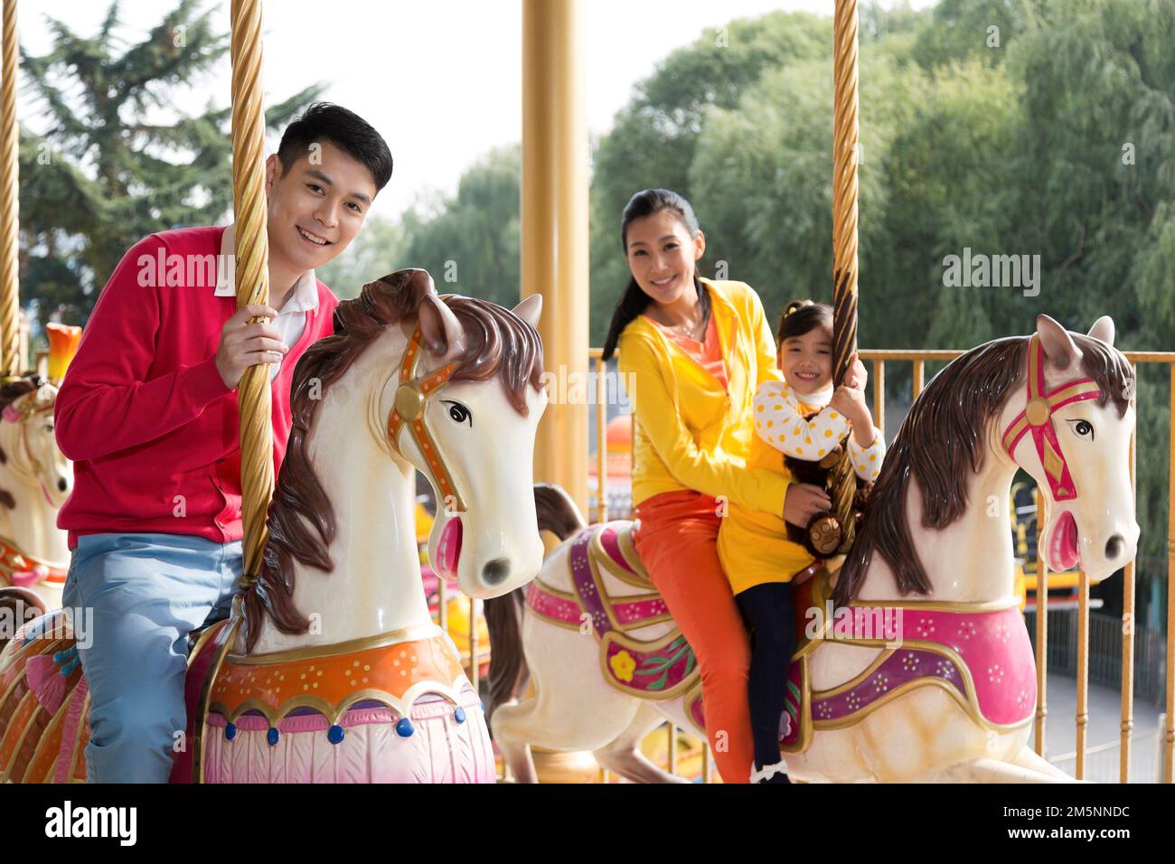 My happy to play in the amusement park ride the merry-go-round Stock ...