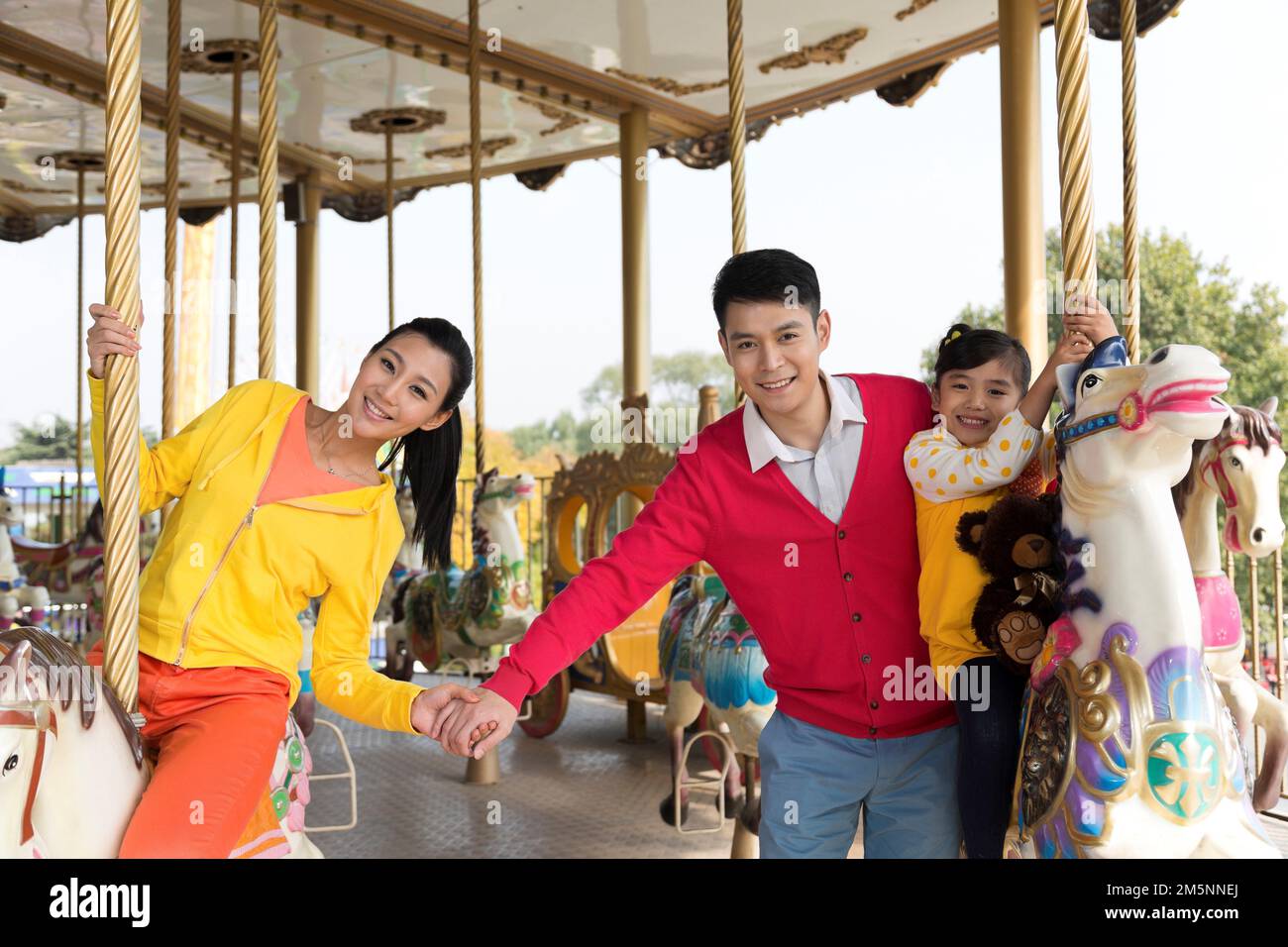 My happy to play in the amusement park ride the merry-go-round Stock ...