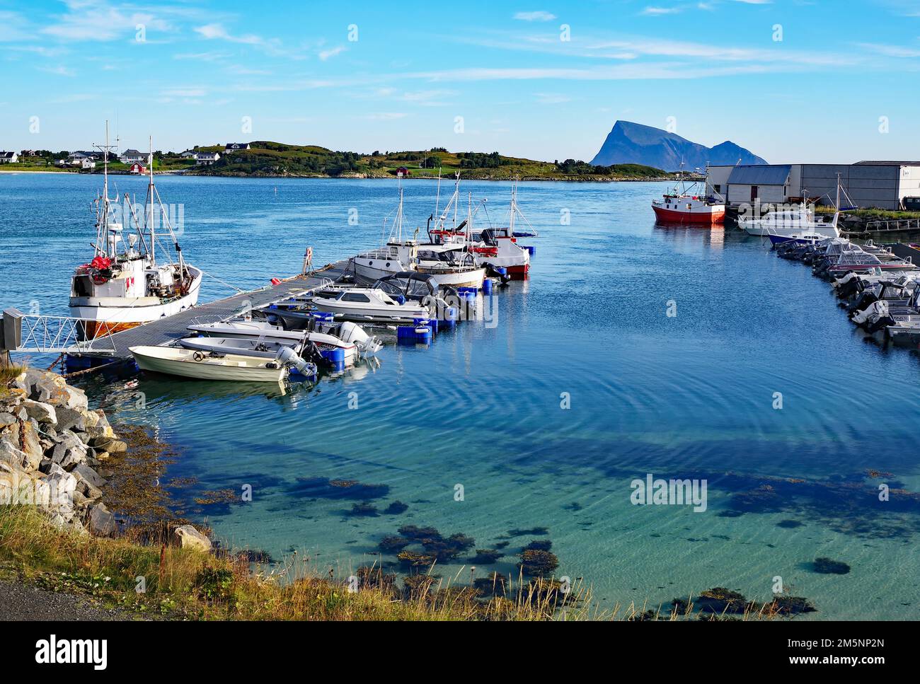 Crystal clear bays and sandy beaches on Sommaroy, small pleasure boats ...
