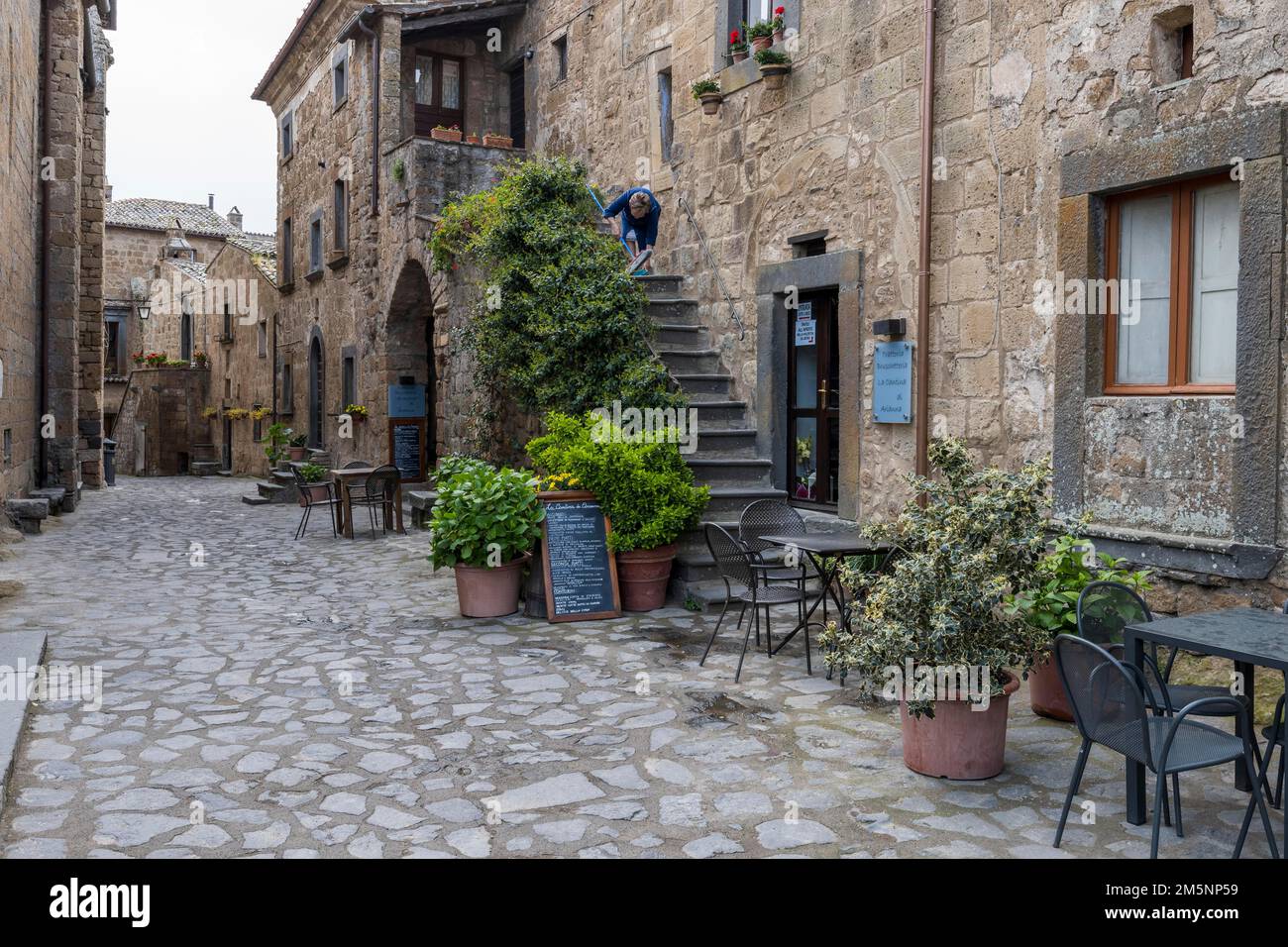 Old tufa buildings decorated with flowers in the hilltop village of ...