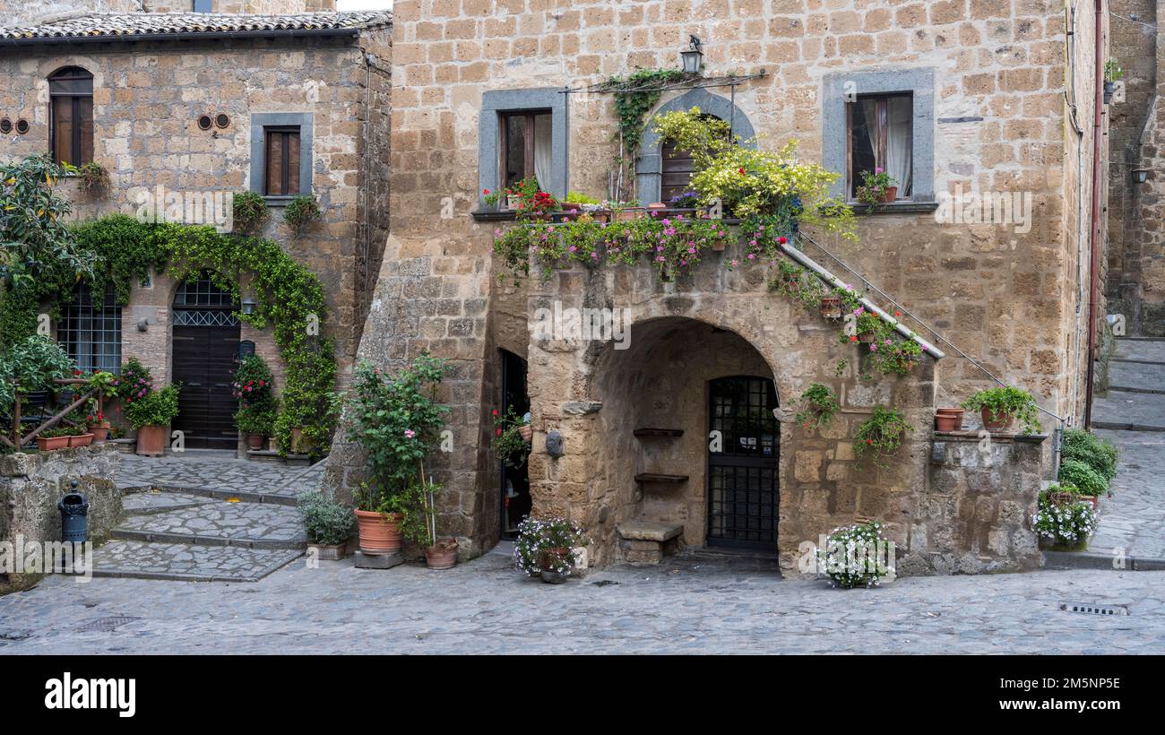 Old tufa buildings decorated with flowers in the hilltop village of ...