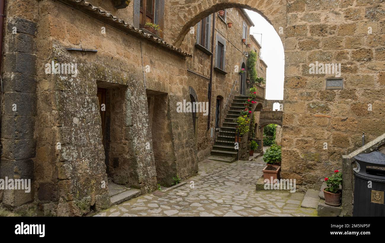 Old tufa buildings decorated with flowers in the hilltop village of ...