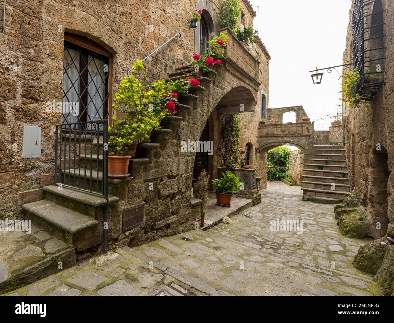 Old tufa buildings decorated with flowers in the hilltop village of ...