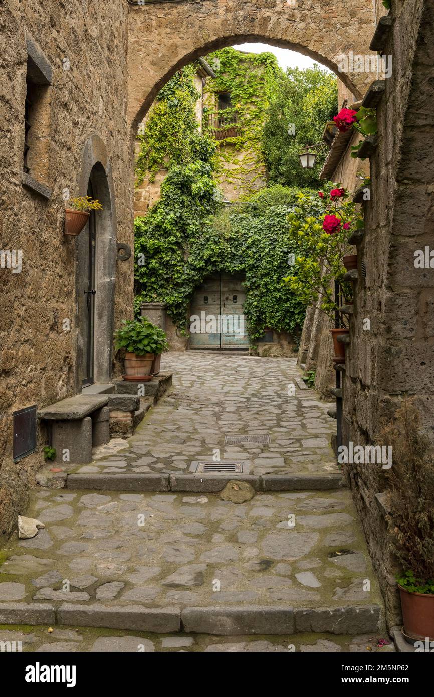 Old tufa buildings decorated with flowers in the hilltop village of ...