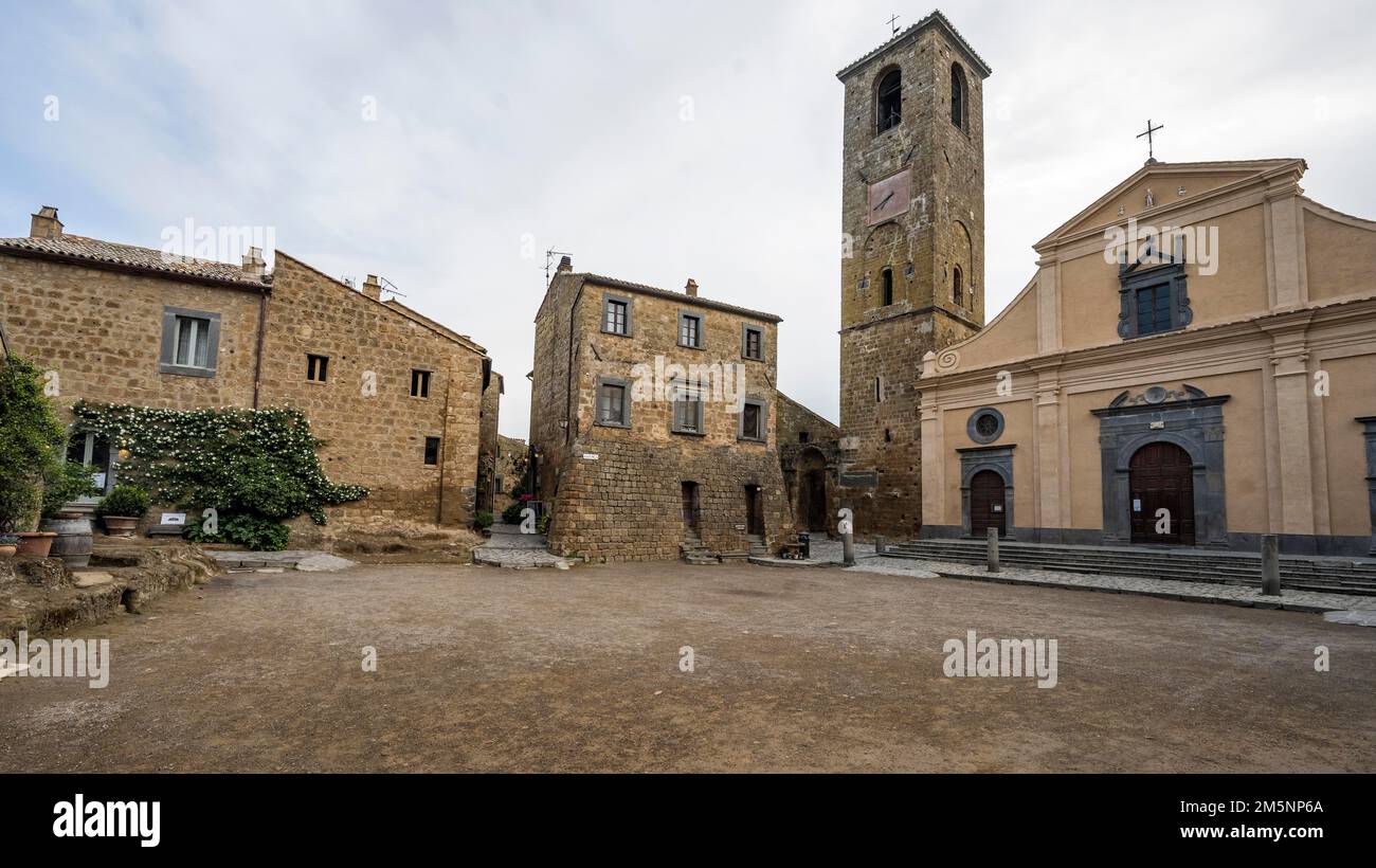 Old tufa buildings and Chiesa San Donato in the hilltop village of ...