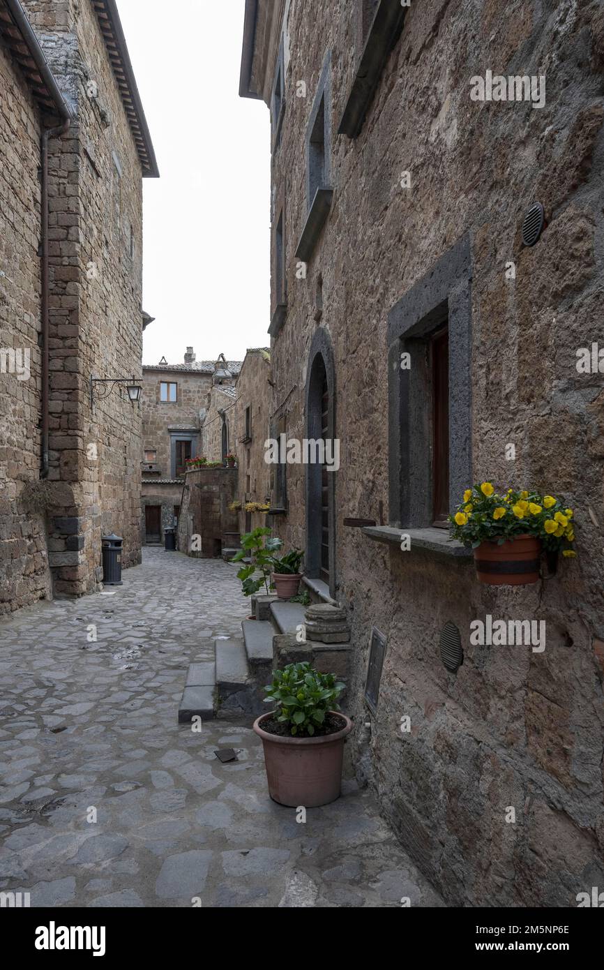 Old tufa buildings decorated with flowers in the hilltop village of ...