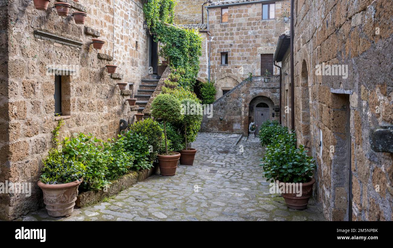 Old tufa buildings decorated with flowers in the hilltop village of ...