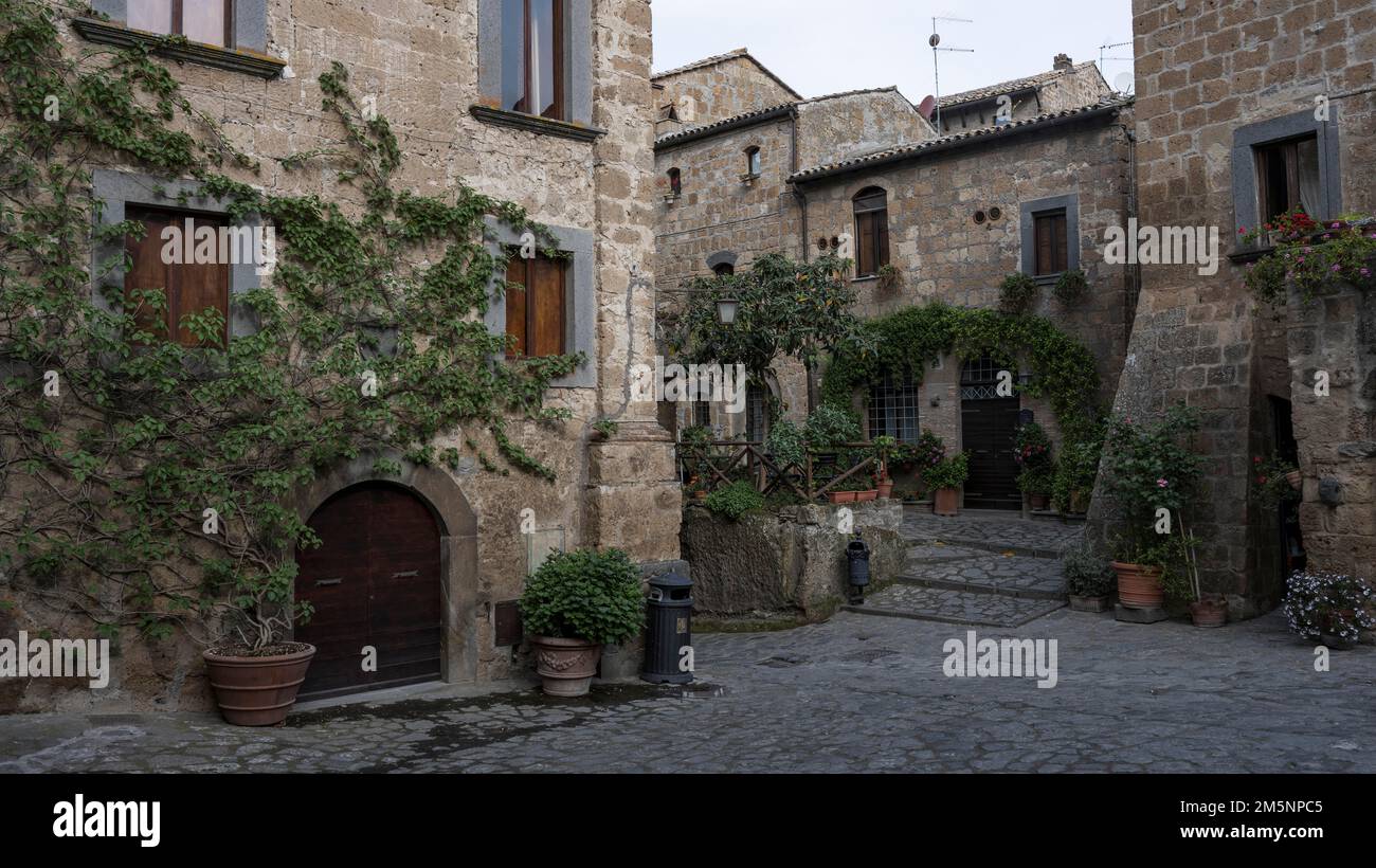 Old tufa buildings decorated with flowers in the hilltop village of ...