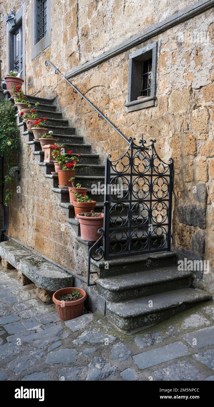 Staircase with flowers by old tuff building in the hill village of ...