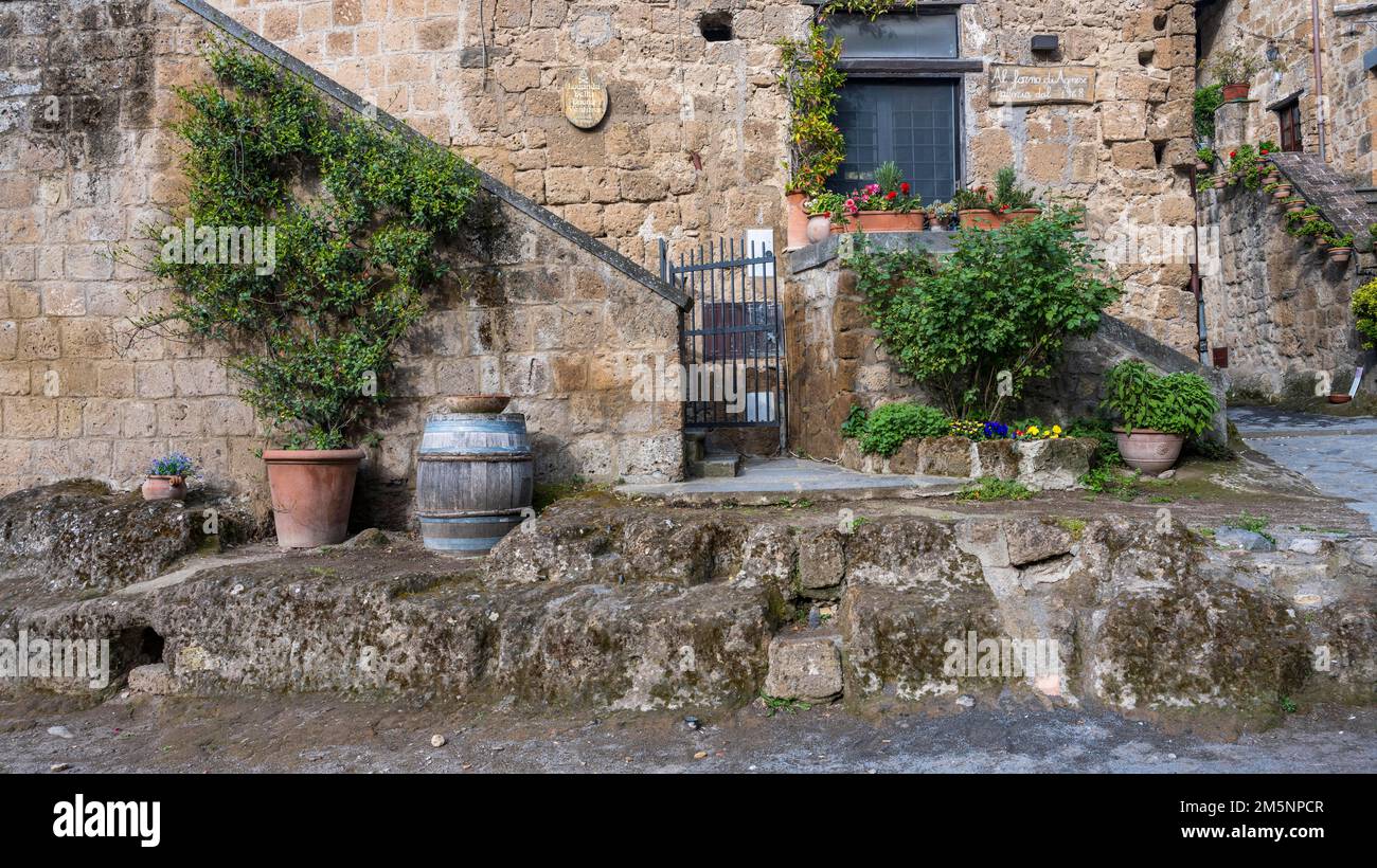 Old tufa buildings decorated with flowers in the hilltop village of ...
