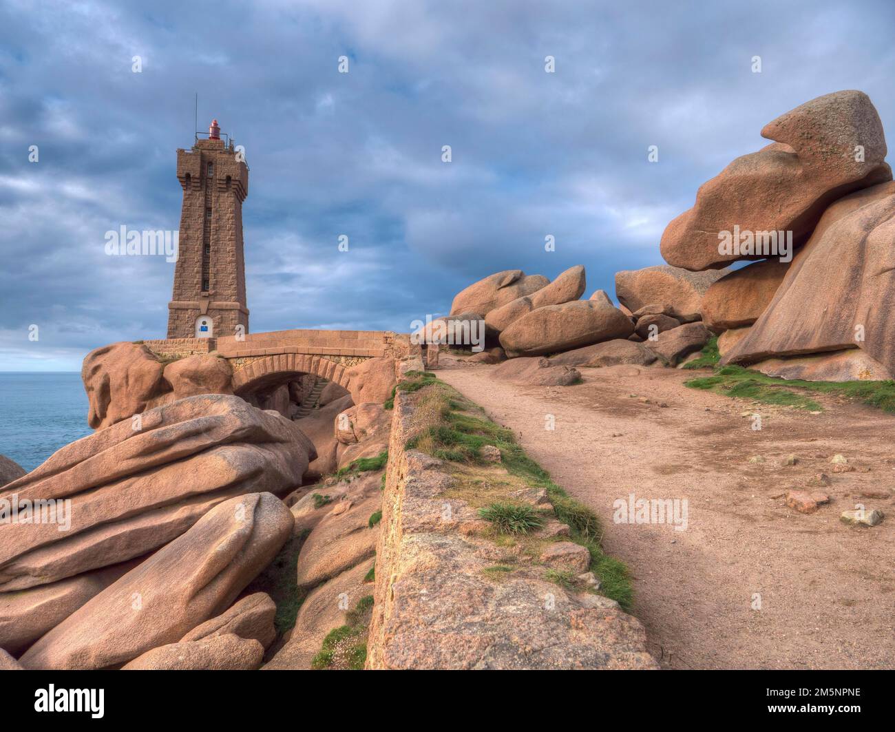 Phare de Ploumanach lighthouse and the beautiful pink granite rock formations of Cote Granit ...