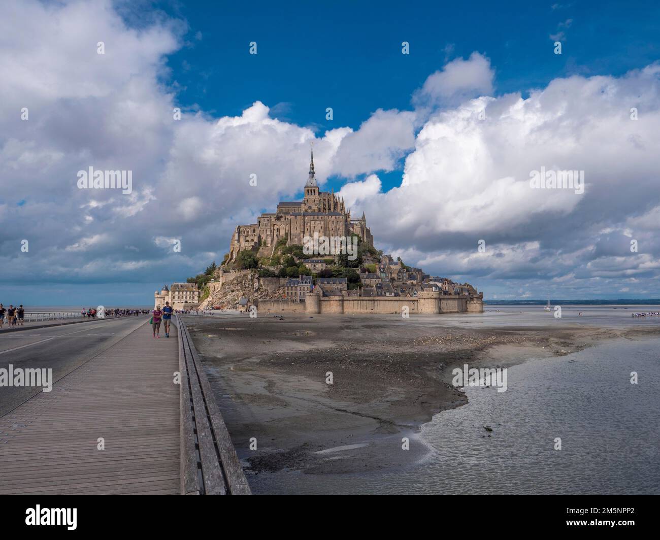View of Mont Saint-Michel from the bridge, Pont Passerelle, with blue ...