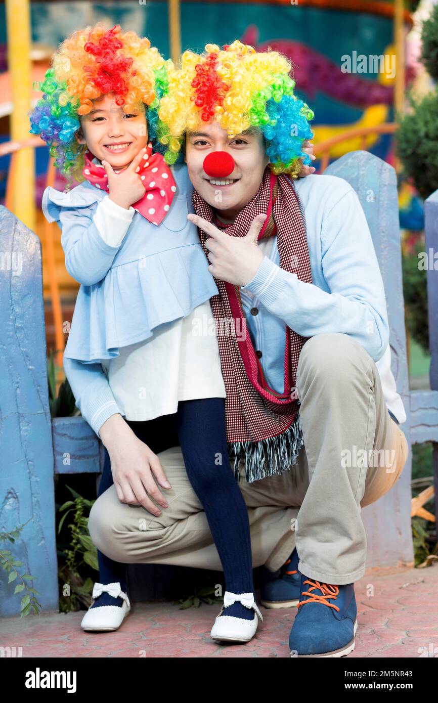 Happy father and clown in the amusement park to play Stock Photo - Alamy