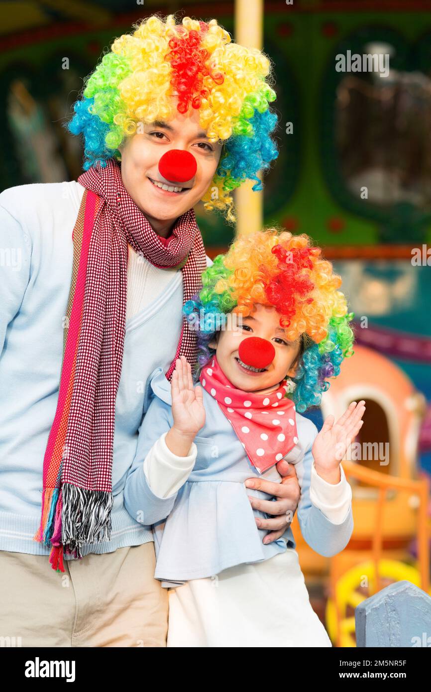 Happy father and clown in the amusement park to play Stock Photo - Alamy