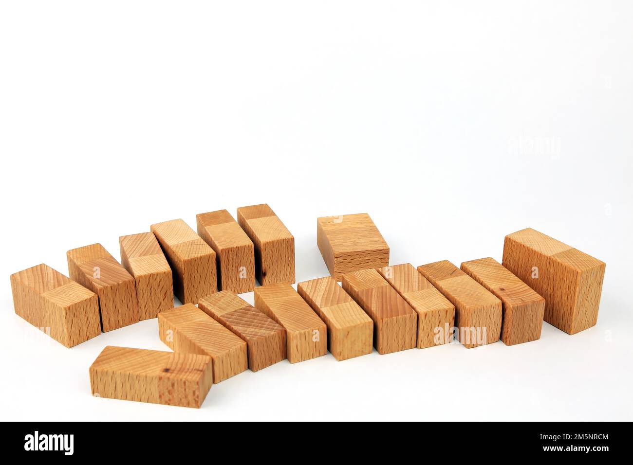 Wooden blocks are set up like a chart or a staircase, set against a ...