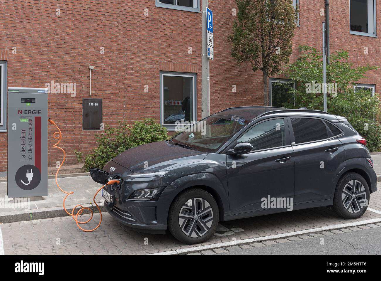 Electric car charging at a charging station, Nuremberg, Middle ...