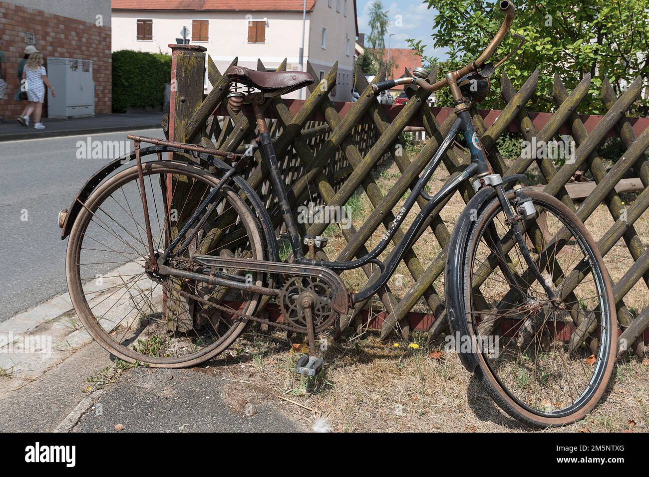 Old ladies' bicycle around 1930 leaning against a garden fence, Bavaria ...