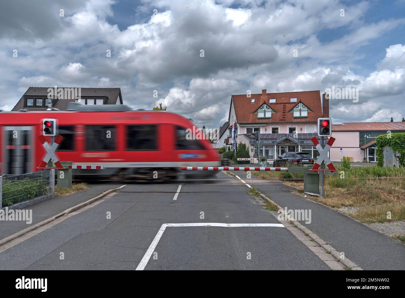 Suburban railway at a level crossing with barriers, Eckental, Middle ...