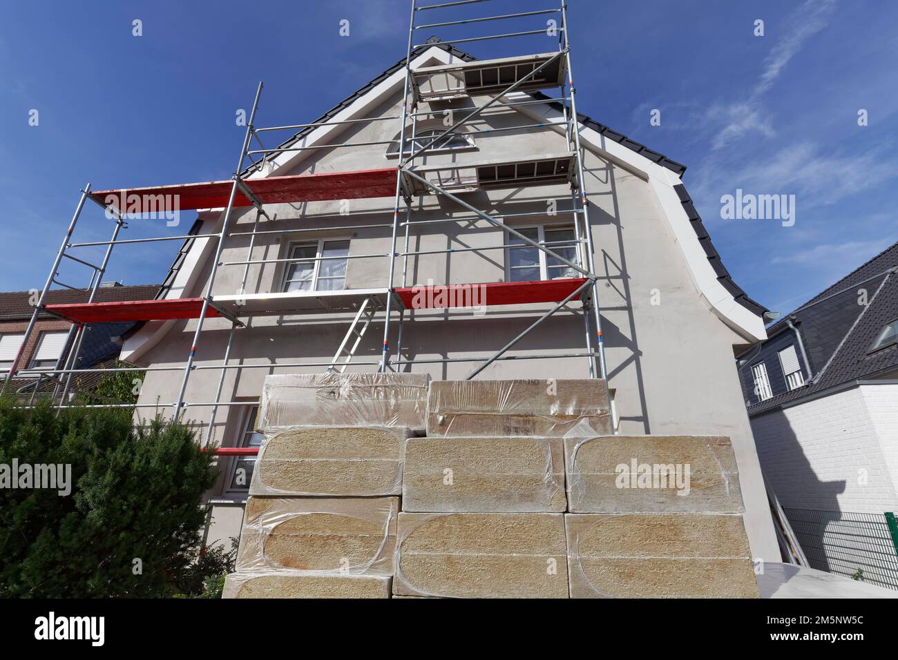 Rock wool insulation panels, stacked in front of a single-family house ...