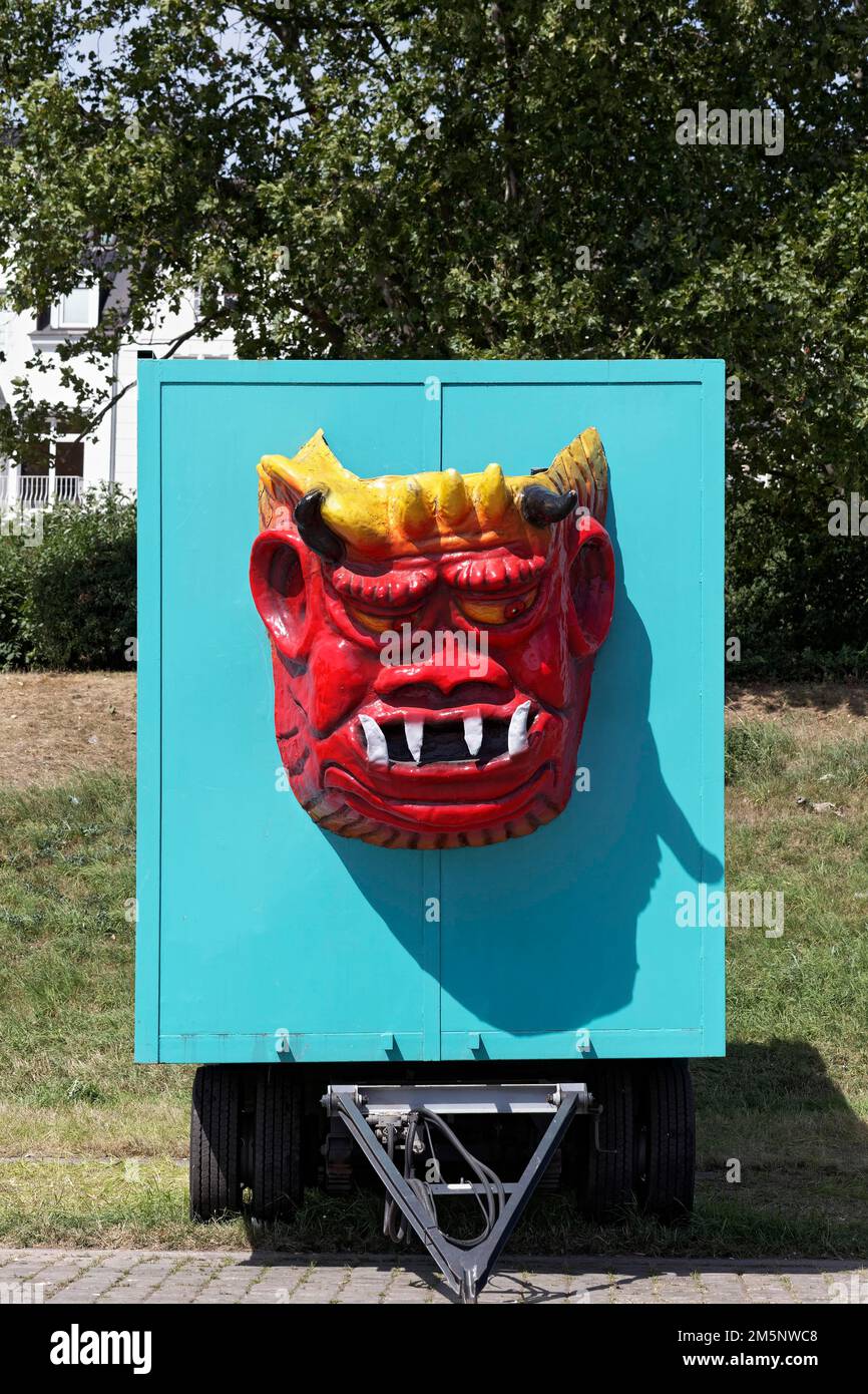 Devil's grimace, face of a monster with fangs and horns on a fairground ...