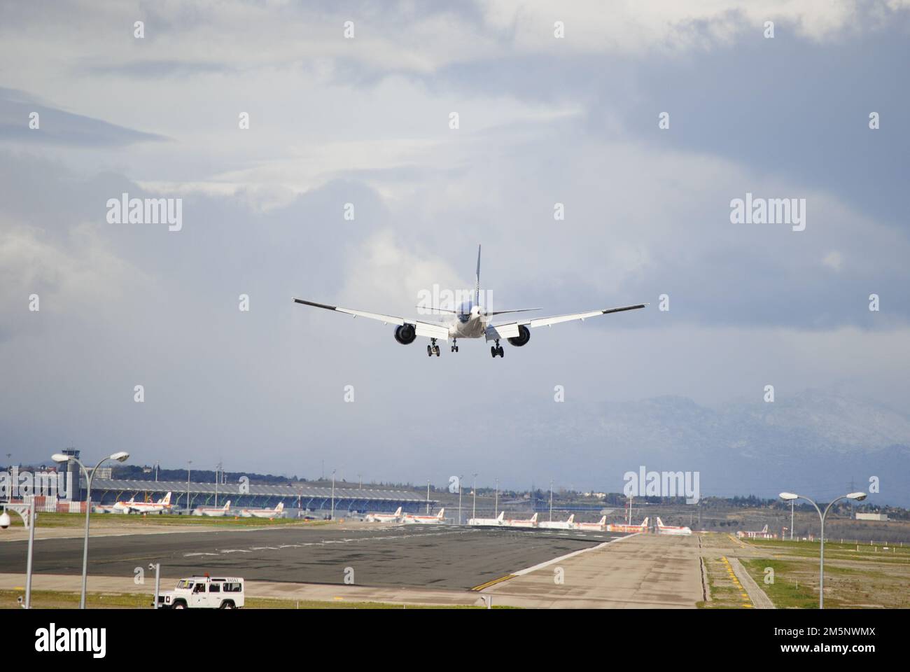 An aircraft plane taking off and flying over the Airport Runway under a ...