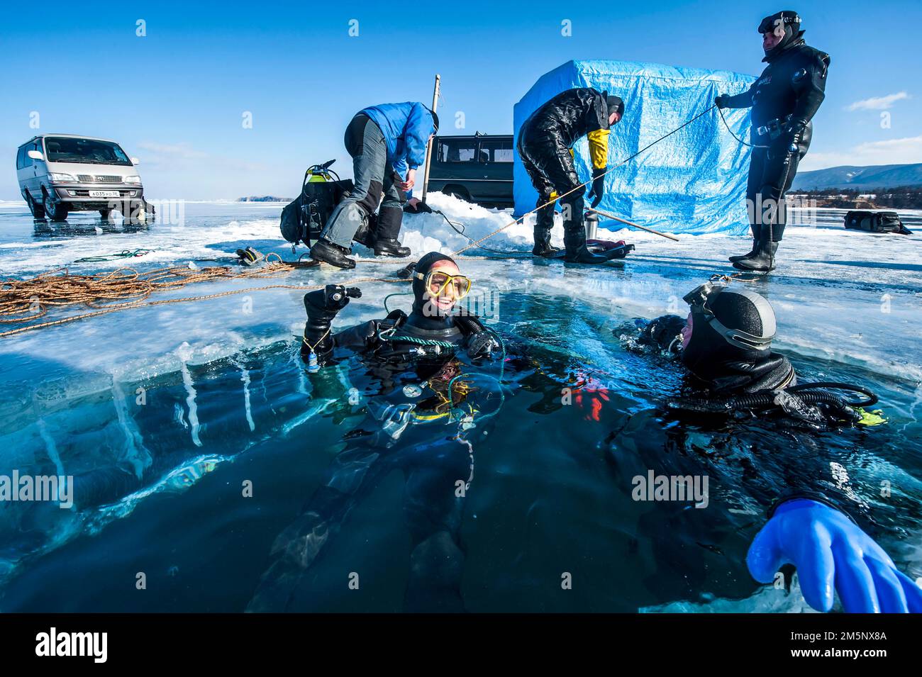 Scuba divers after an ice dive, Lake Baikal, Pribaikalsky National Park ...