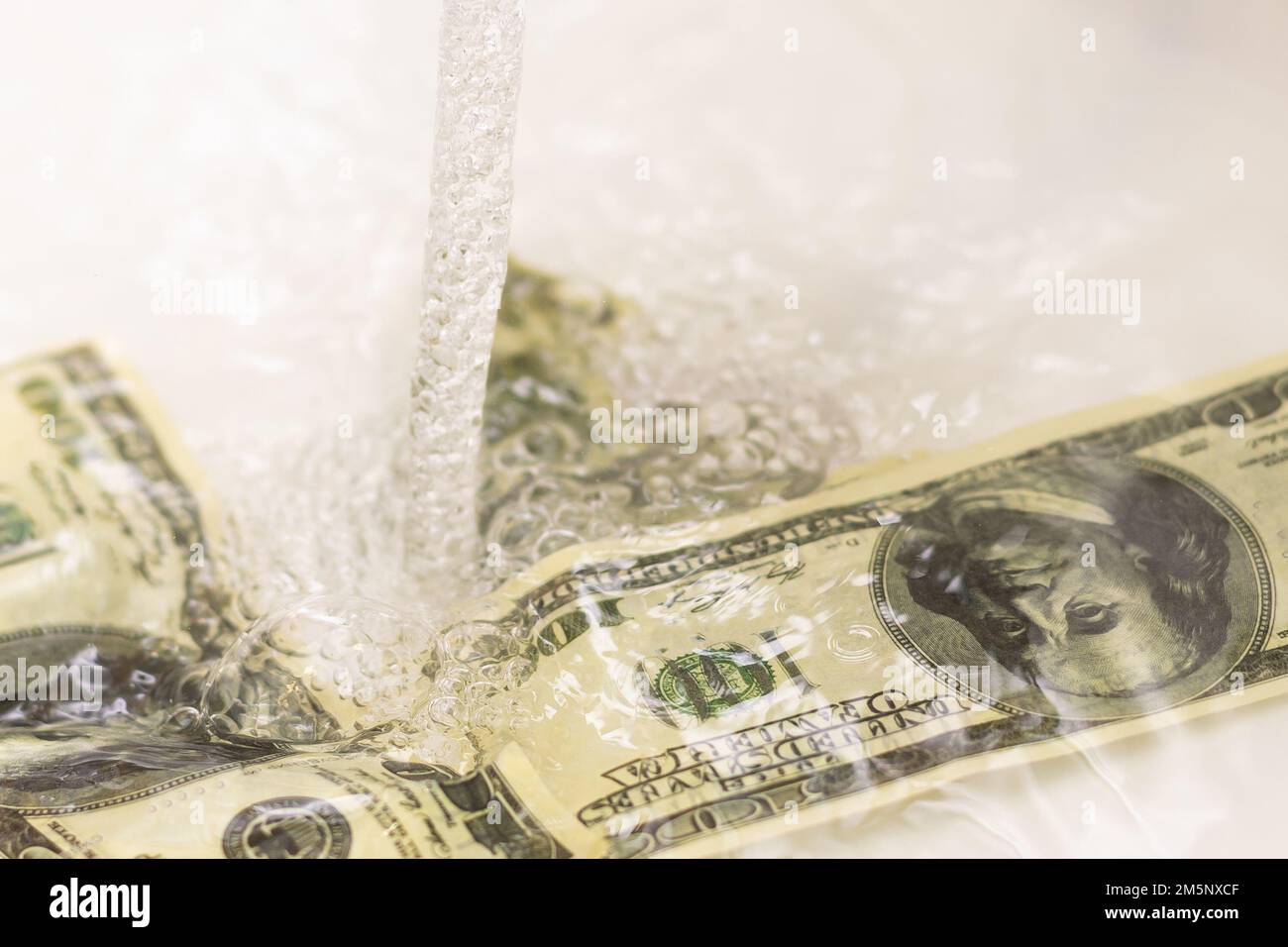 Cash Money Going Down Sink Drain Isolated on White Background Stock ...