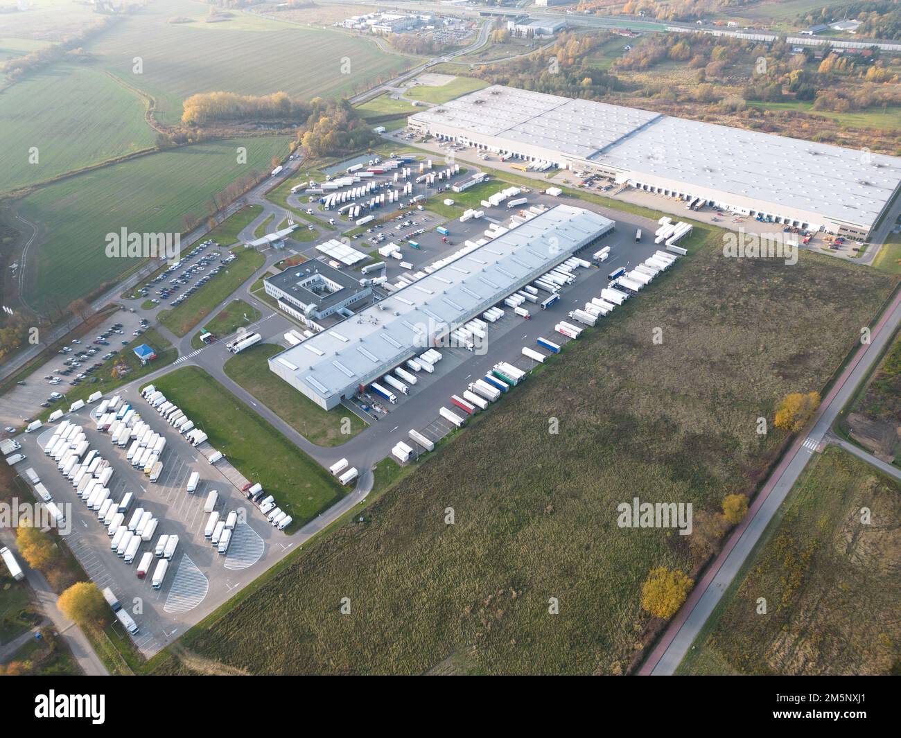 Aerial Shot of Industrial Warehouse Loading Dock where Many Truck with ...