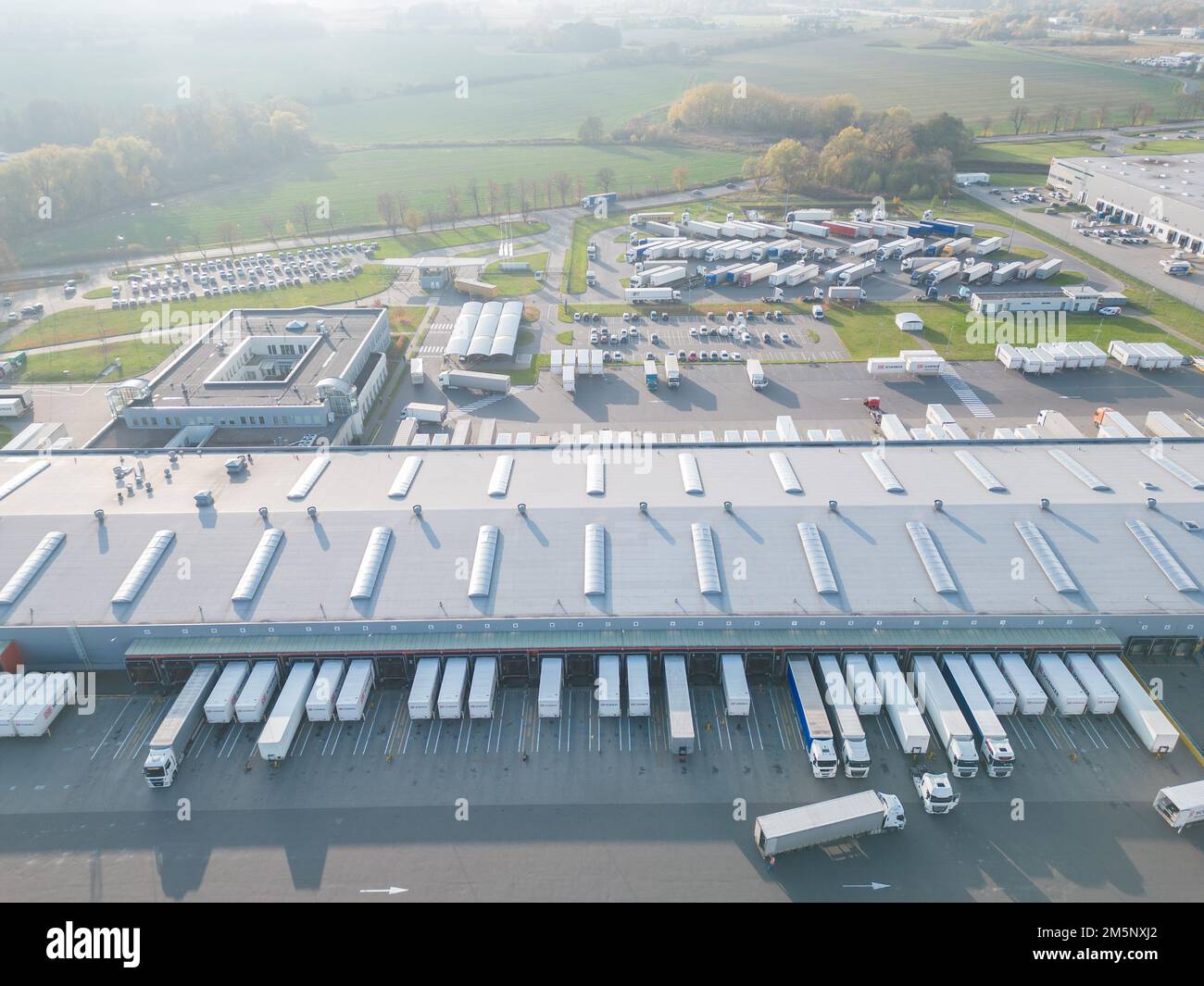Aerial Shot of Industrial Warehouse Loading Dock where Many Truck with ...