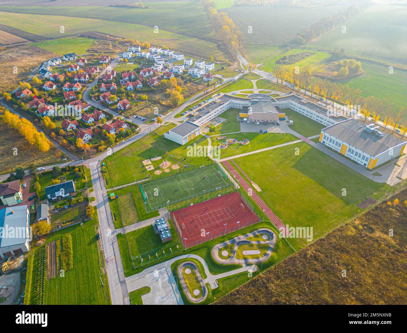 Aerial view of small european town with sradium and sport field ...