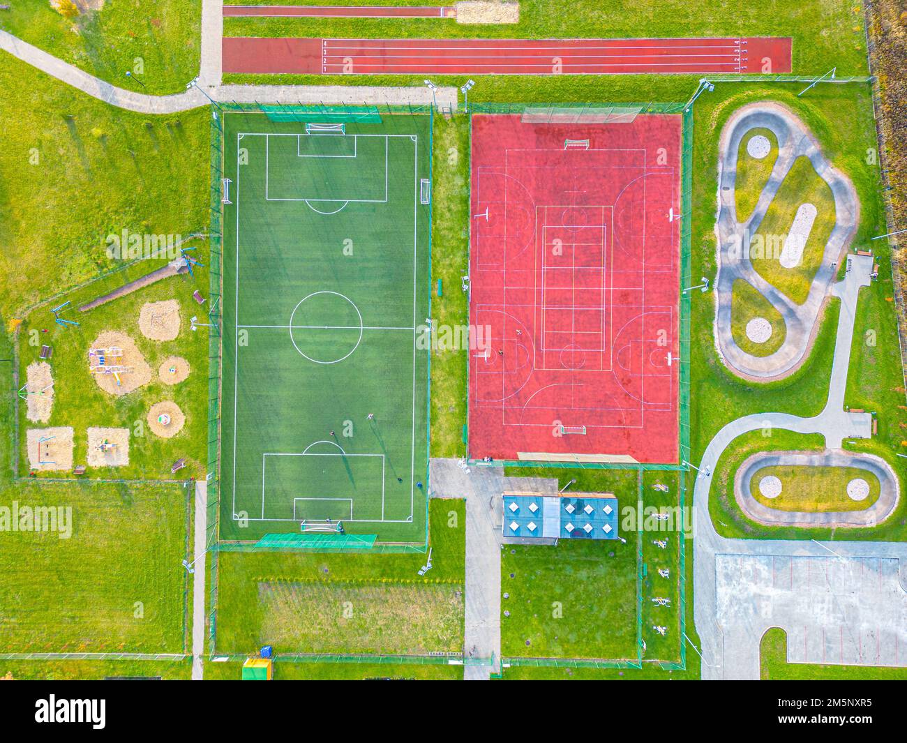 school sports ground with football stadium, jogging tracks around ...