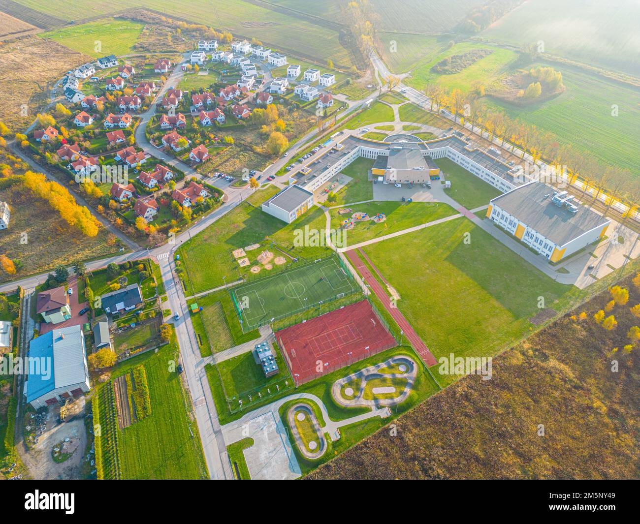 Aerial view of small european town with sradium and sport field ...