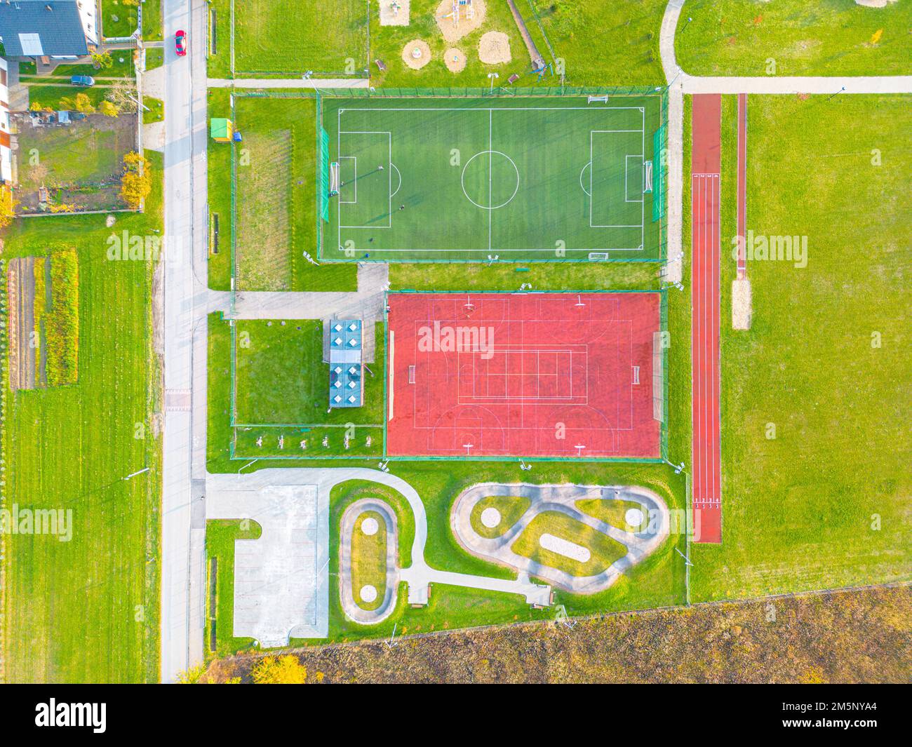 school sports ground with football stadium, jogging tracks around ...