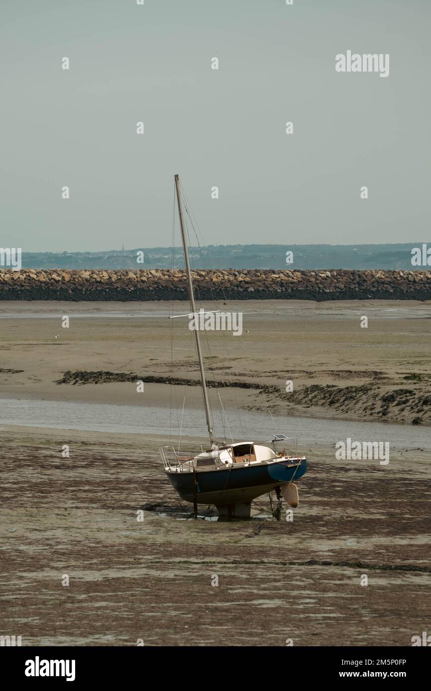 A boat on low tide on a beach in brittany Stock Photo - Alamy