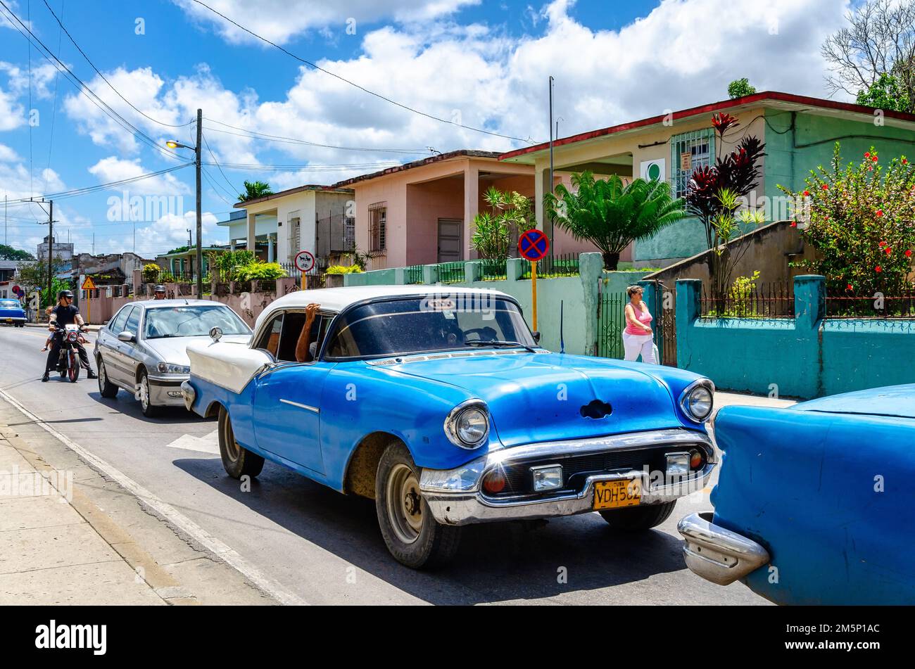 Vintage obsolete American cars are waiting for the stop light to change ...