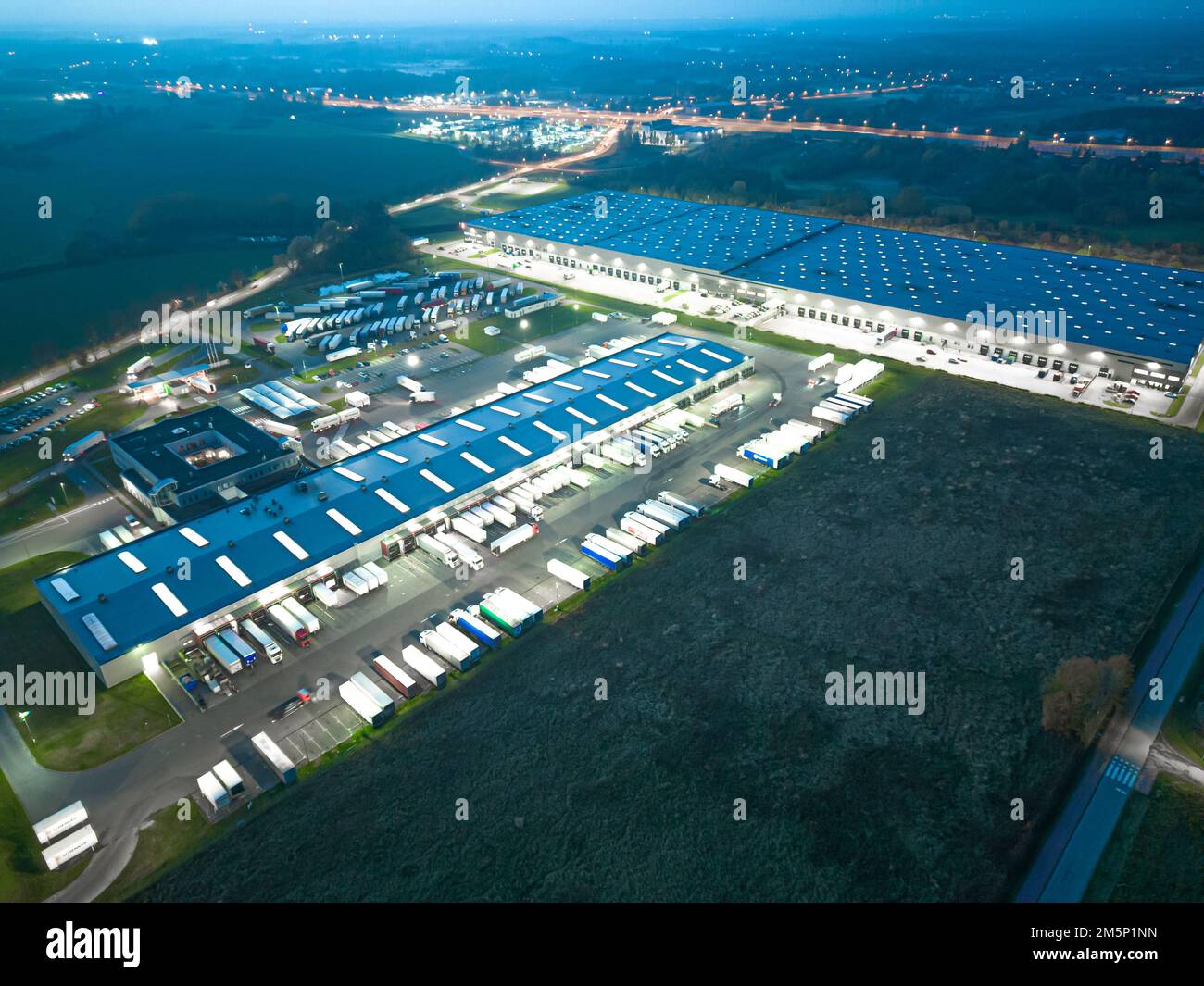 Night aerial view of the warehouse of goods. Logistic center in the ...