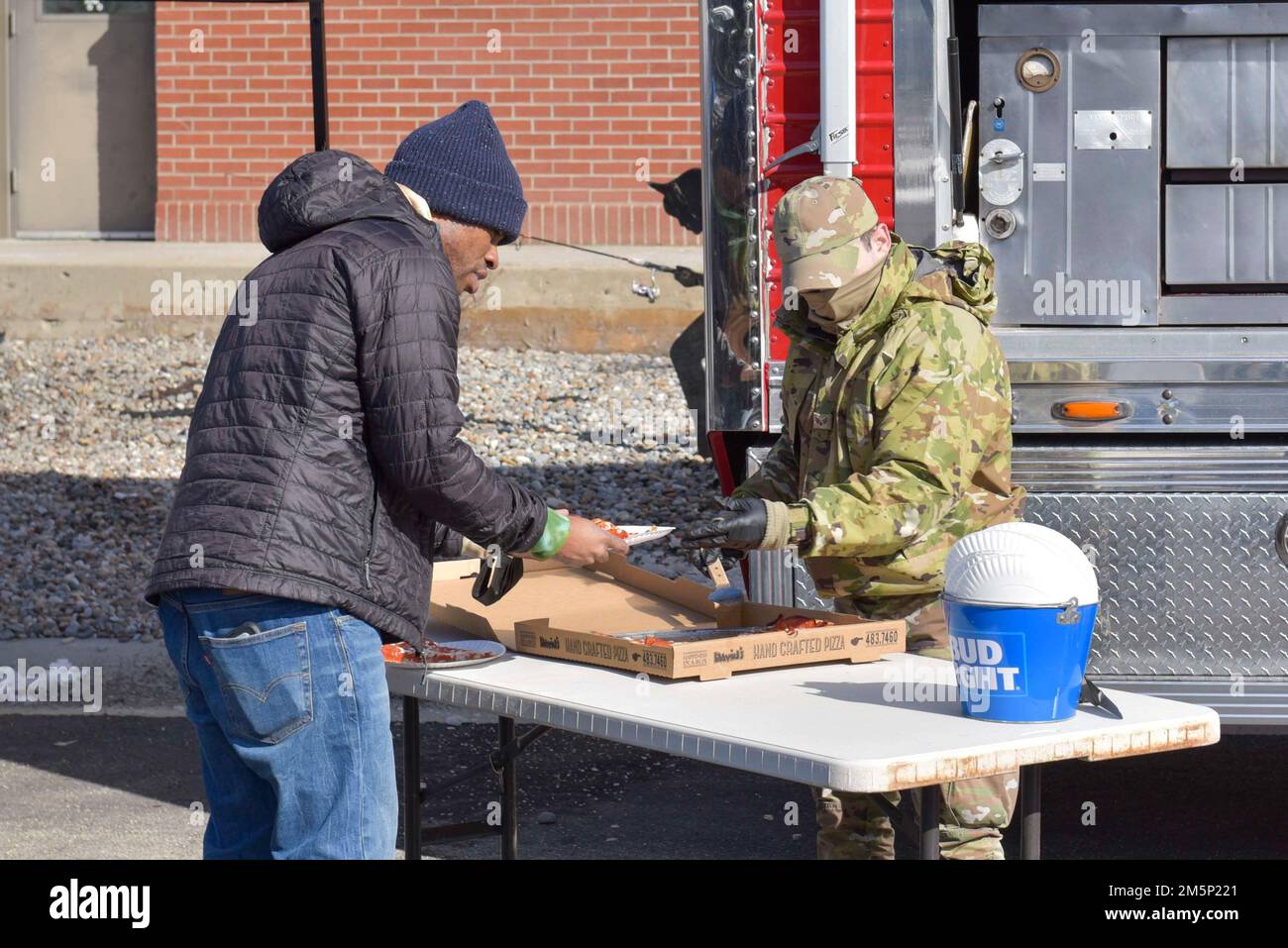 U.S. Air Force Airman (right) serves lunch to a Winter Wonderland ...
