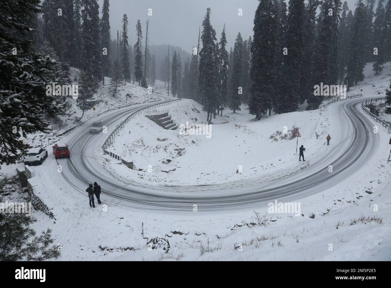 Srinagar, India. 29th Dec, 2022. A car on a snow-covered hilly area ...